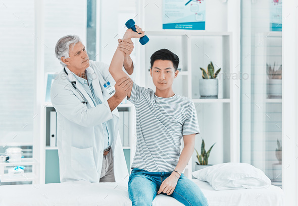 Hes been working on his strength. Shot of a mature doctor testing his ...
