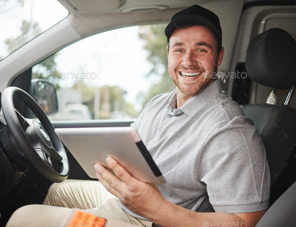 Cropped portrait of a handsome young delivery man using a tablet while ...