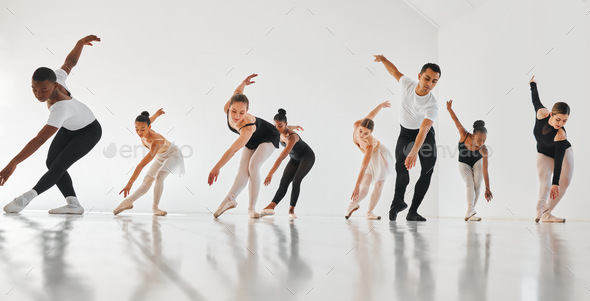 Shot of a group of young ballet dancers practicing their routine in a ...