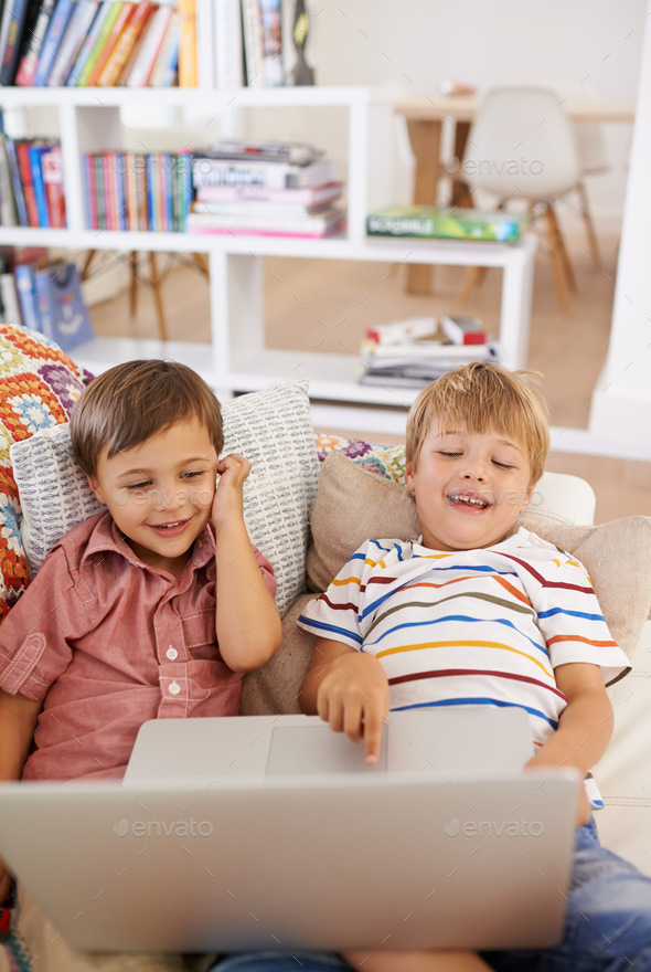 Its story time. Two boys watching stories on a laptop. Stock Photo by ...