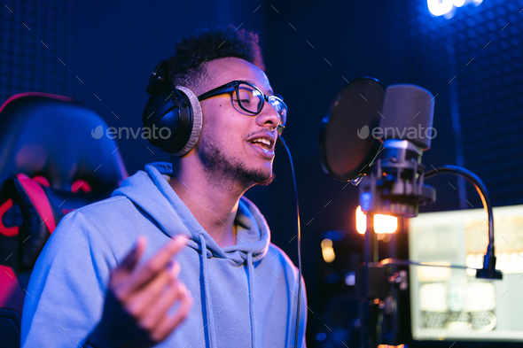 Young male singer in recording studio performing in neon lights Stock ...