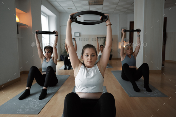People with real bodies doing Pilates exercises in class Stock Photo by ...