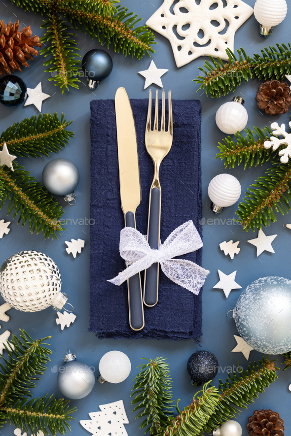 Blue and white Christmas table setting with decorations and fir tree ...