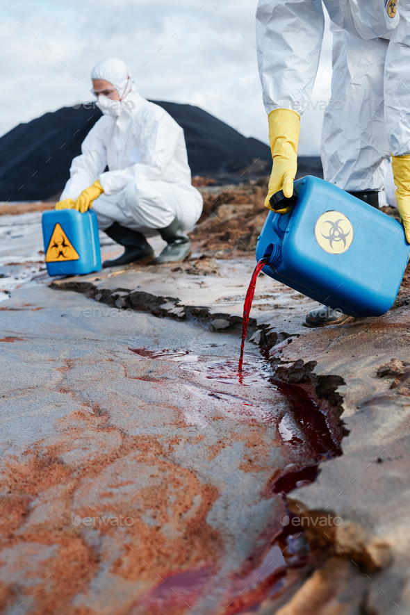 Ecological specialists pouring red toxic liquid into water Stock Photo ...