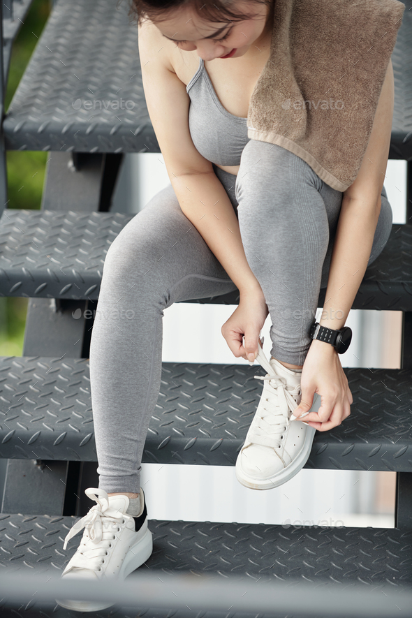 Fit Woman Tying Shoe Laces Stock Photo by DragonImages | PhotoDune