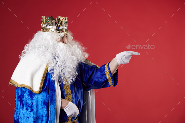 The Magician King pointing at a billboard on a red background Stock ...
