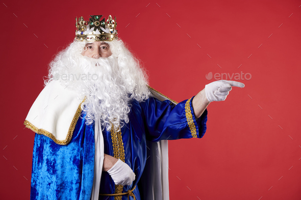 The Magician King pointing at a billboard on a red background Stock ...