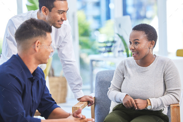 Shot of three businesspeople having a conversation in a modern office ...