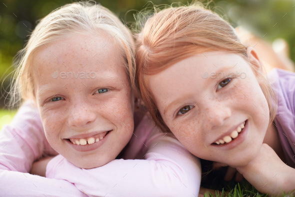 Best friends. Two little girls lying happily on the grass. Stock Photo ...