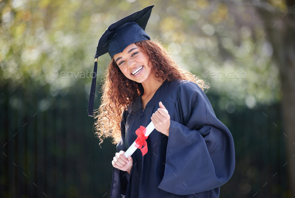 Portrait of a young woman holding her diploma on graduation day Stock ...