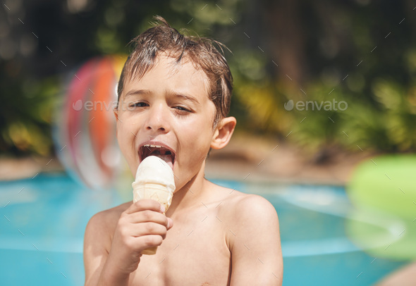 Cropped portrait of an adorable little pool eating an ice cream while ...