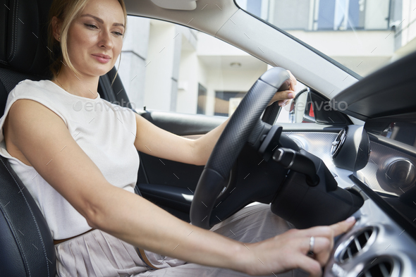 Caucasian woman starts the car engine Stock Photo by gpointstudio ...