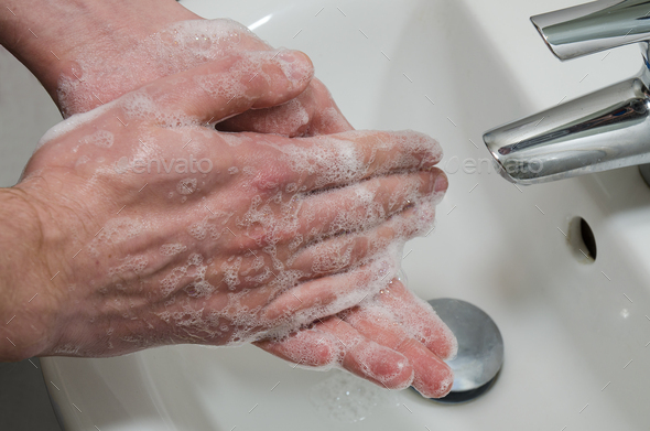 Man washing hands in the bathroom. Hands close up with hand-wash foam ...