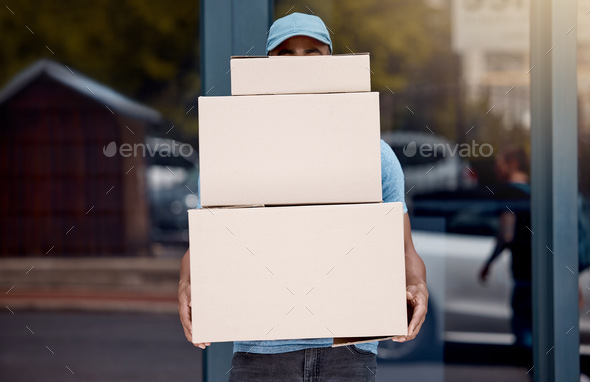 Manage tons of orders on the daily. Shot of a young delivery man ...