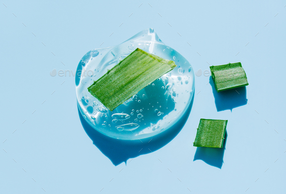 aloe vera on blue background cosmetic sample serum gel smear top view ...