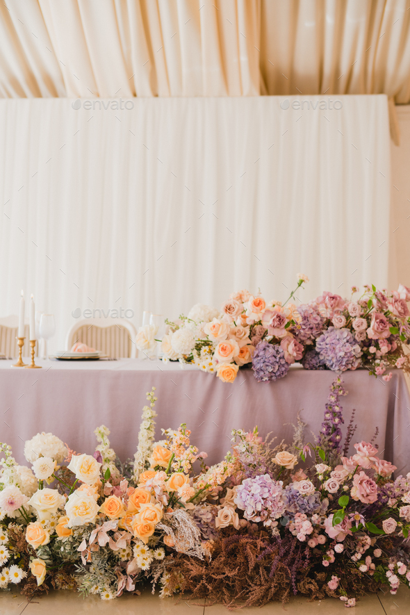 Table setting at the wedding reception. Floral compositions with ...