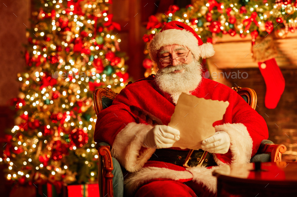 Santa Reading Letter On Christmas Stock Photo by seventyfourimages