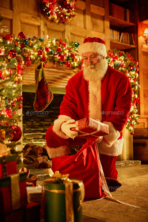 Fairytale Santa Leaving Christmas Presents Stock Photo by seventyfourimages