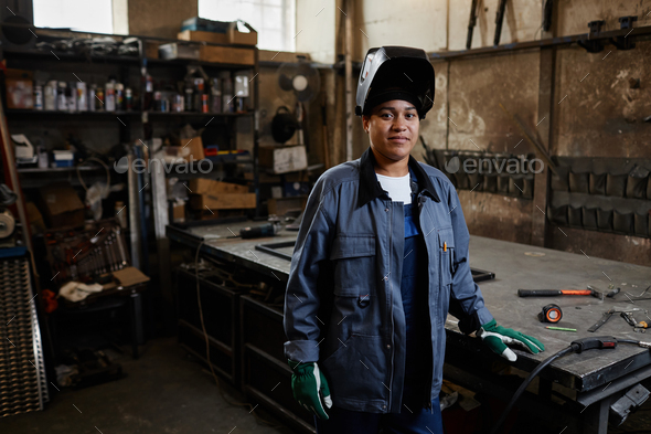 Smiling Female Welder At Factory Stock Photo by seventyfourimages ...