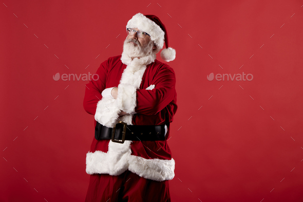 Santa Claus with crossed arms on a red background Stock Photo by yosss1
