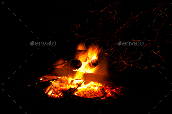 Campfire as a symbol of warmth and life on black Stock Photo by pilens