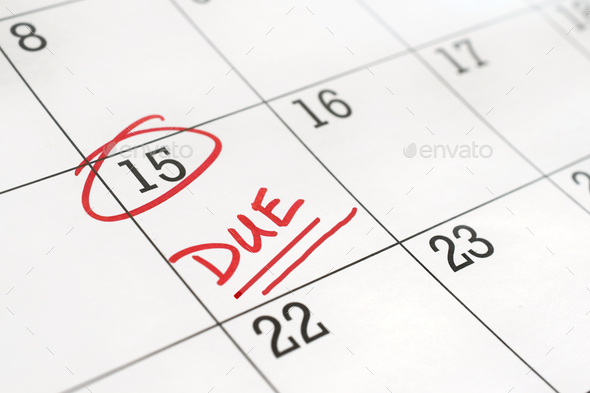 Calendar with the 15th of the month circled and word DUE written on it ...