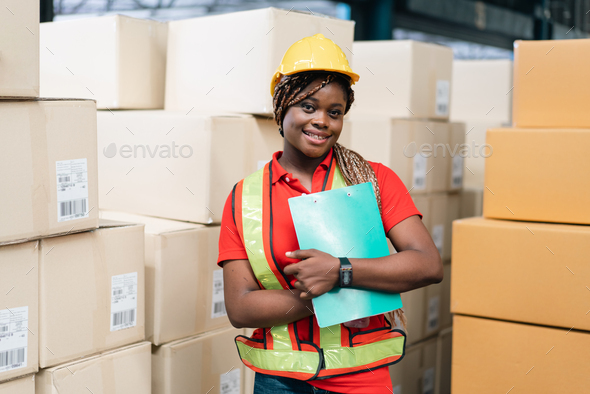 Portrait of smiling African female worker holding checklist with boxex ...