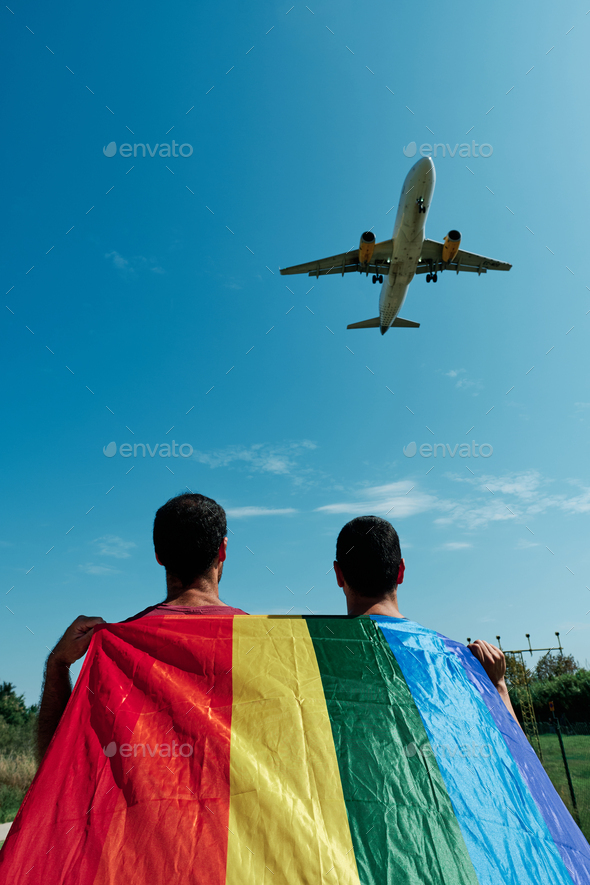 two gay man with the gay pride flag and an airplane Stock Photo by ...