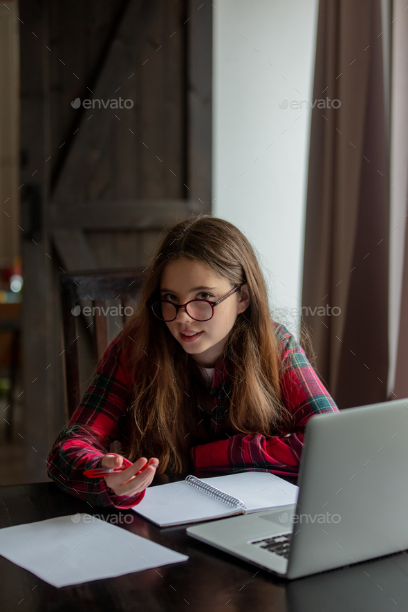 teenage girl trying to study at home on a computer Stock Photo by ...