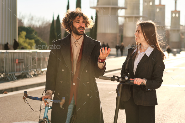Two friends walking together outdoors. Stock Photo by alvarogonzalez