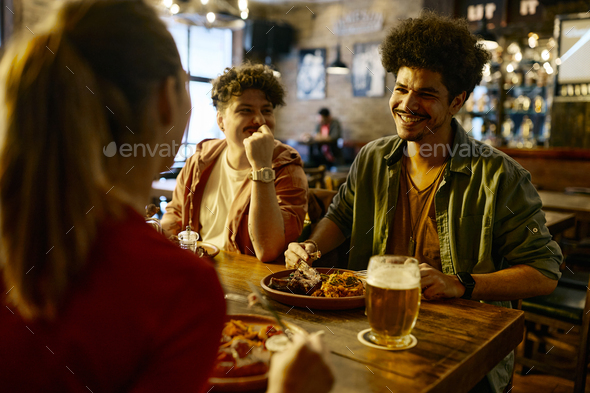 Happy Lebanese man enjoying in conversation with his friends during ...