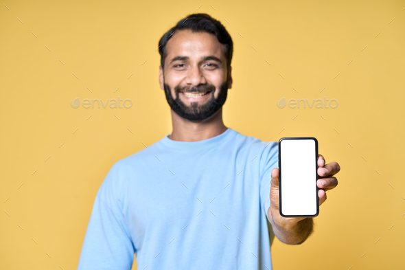 Happy indian man showing mobile phone pointing at screen isolated on ...