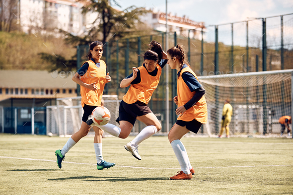 Skillful female soccer player in action during sports training at the ...
