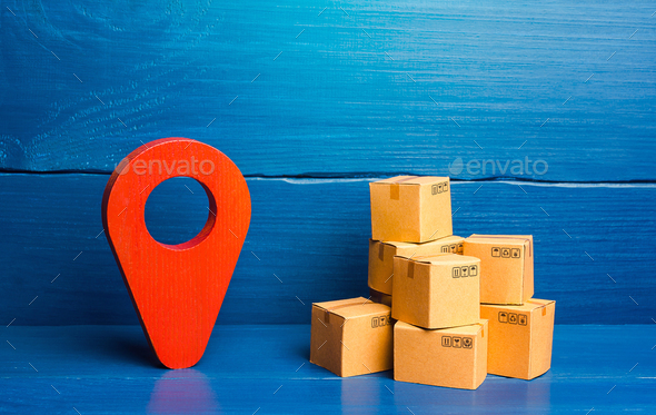 Red location pin pointer symbol and cardboard boxes. Stock Photo by iLixe48