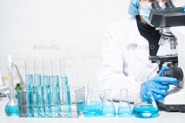 professional research scientist using microscope in science chemistry ...