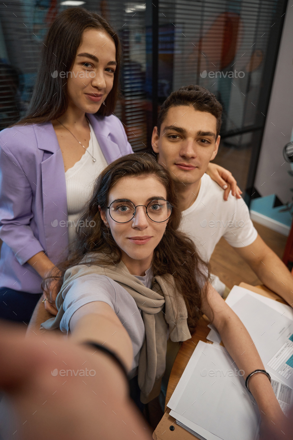Three young employees take a cute selfie in the office Stock Photo by ...