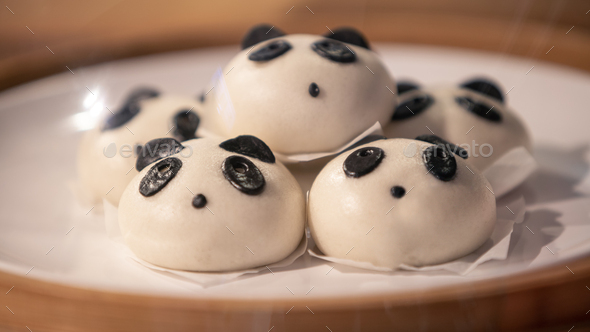 Chinese steamed buns in shape of cute pandas on wooden basket. Panda ...