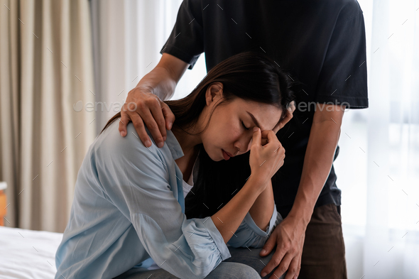 Young man comforting and supporting a sad woman who is in serious ...