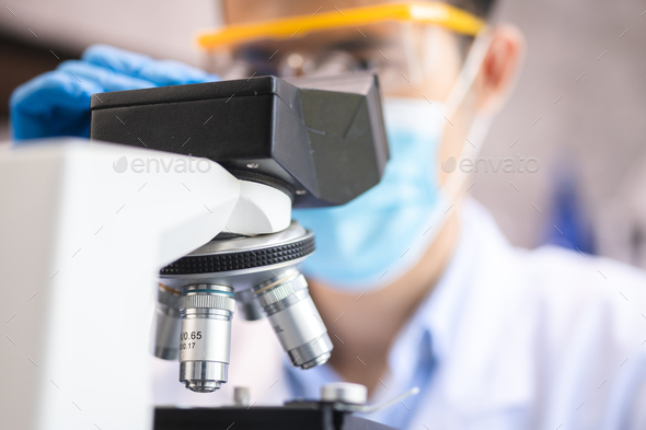 professional research scientist using microscope in science chemistry ...