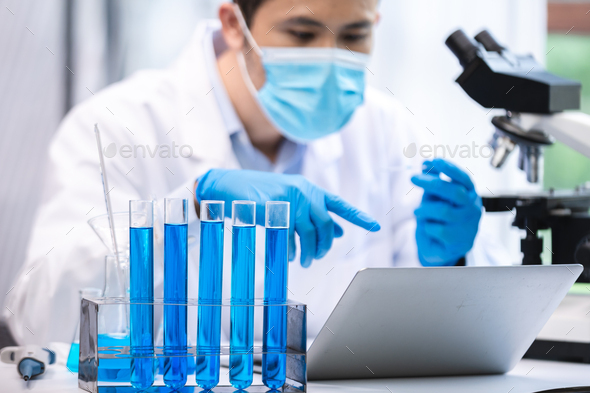 professional research scientist using microscope in science chemistry ...