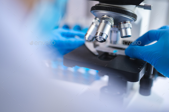 professional research scientist using microscope in science chemistry ...