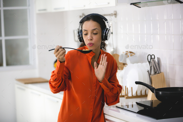 Cheerful young female chef and vlogger recording and going live on ...