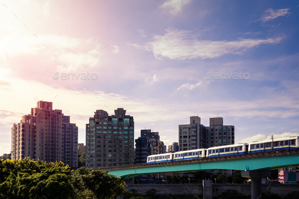 Elevated train passing over bridge. Awesome cityscape with modern metro ...