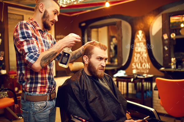Time for a new hairdo. Handsome young bearded man came to the barber ...