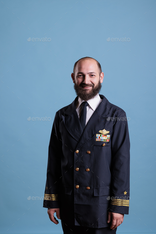 Airplane captain wearing uniform portrait Stock Photo by DC_Studio