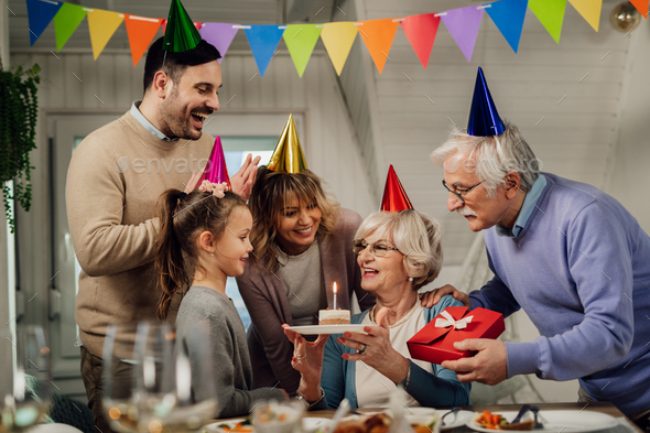 Cheerful multi-generation family celebrating grandmother's Birthday in ...