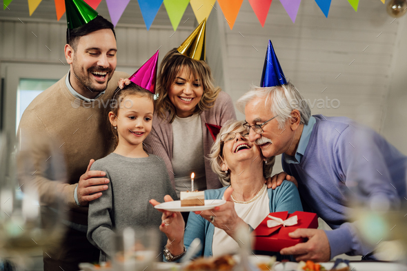 Happy multi-generation family having fun on Birthday party in dining ...
