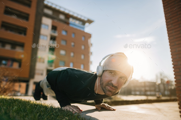 Young smiling athlete doing push-ups on the street. Stock Photo by ...