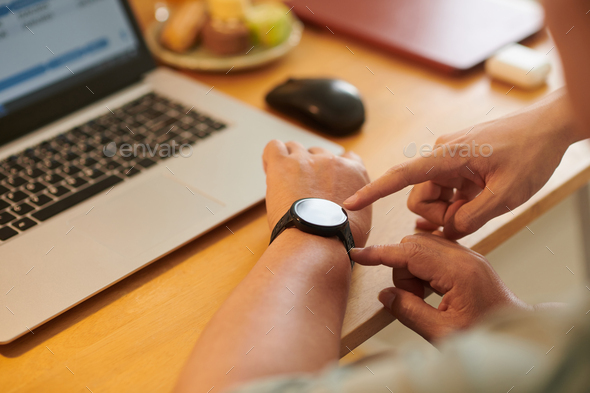 Explaining How to Use Smartwatch Stock Photo by DragonImages | PhotoDune