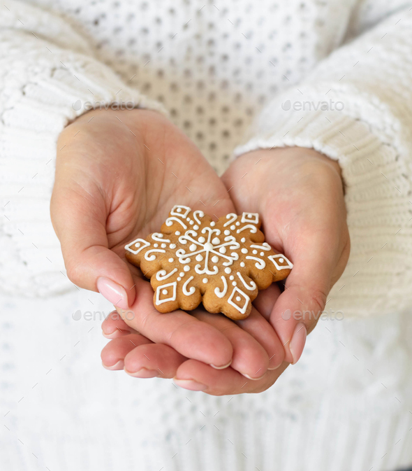Christmas shortbread man. Women's hands hold a traditional New Year's ...